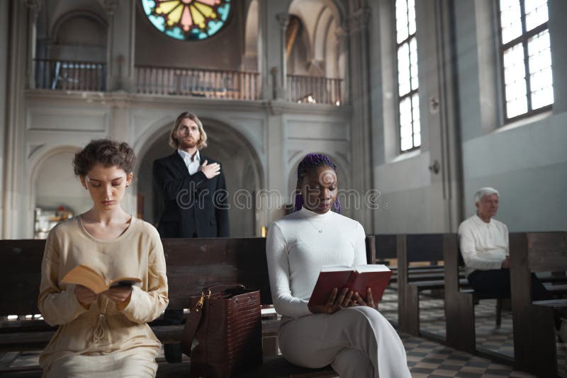People praying during mass stock photo. Image of praying - 217108060
