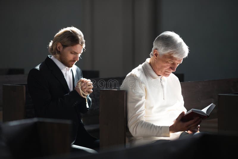 People praying during mass stock photo. Image of praying - 217108060