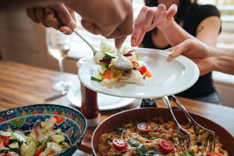 People Putting Food on the Plate and Having Dinner Together Stock Photo ...