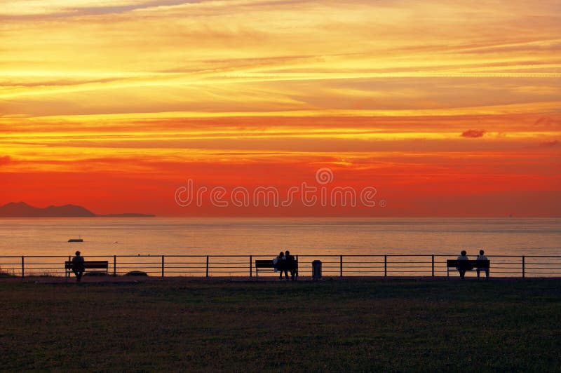 People relaxing on benches stock image. Image of silhouette - 33550901