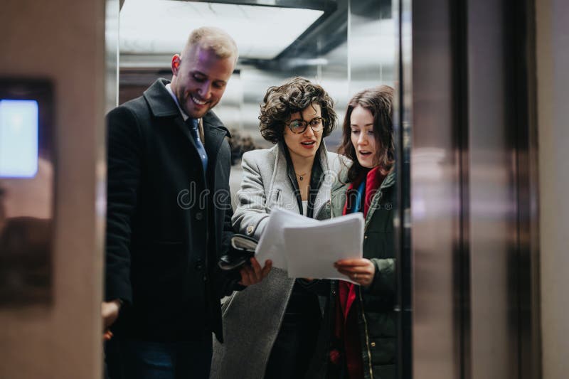 People Reviewing Documents Together in Modern Office Elevator. Stock ...