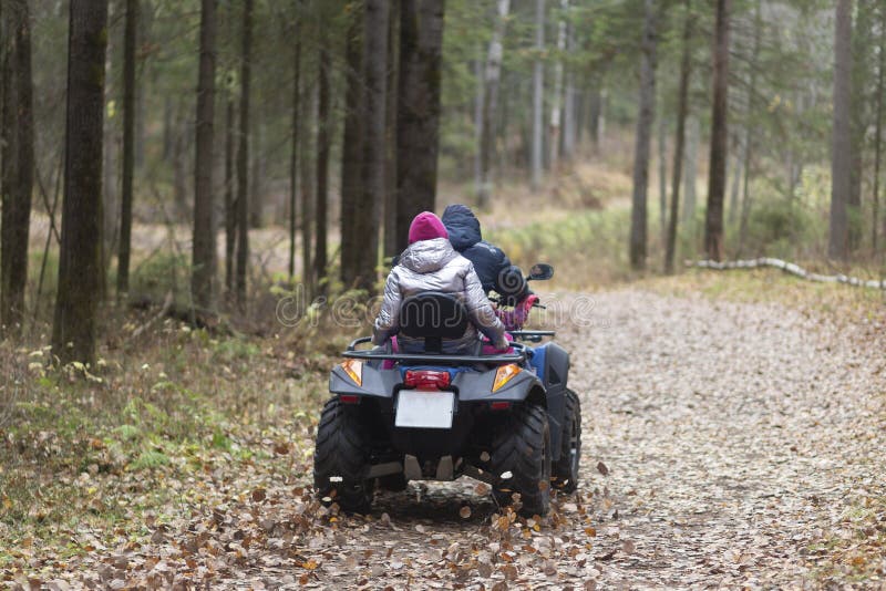 People Ride an ATV in the Autumn Forest.Motor Vehicles Editorial Image ...