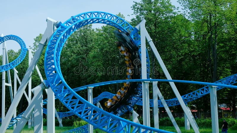 People Ride Upside-down Circle on Blue Roller Coaster Stock Footage ...