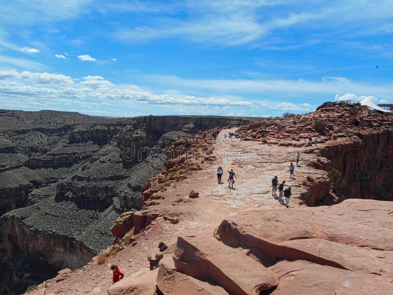 People on a Rock in the Grand Canyon Stock Photo - Image of people ...