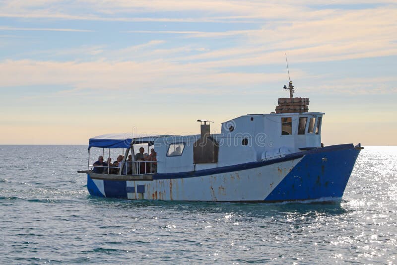 People are Sailing on an Old Boat. Violation of Water Boundaries Stock ...