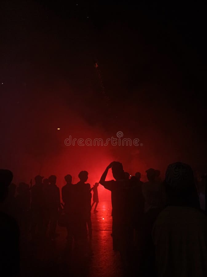 People Set Off Fireworks and Crowds and Red Lights and Fires and Stars ...