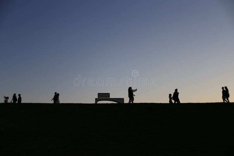 People Silhouette Passing a Lonely Bench Stock Photo - Image of passing ...