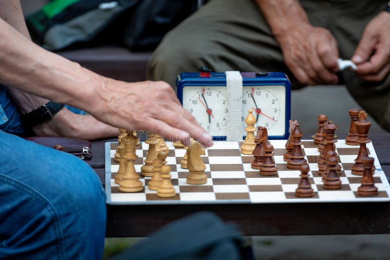 People Sit in the Park on Benches and Play Chess. Stock Image - Image ...