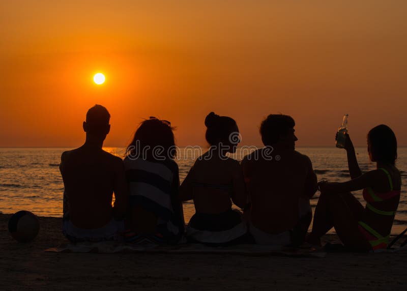 People Sitting on a Beach Looking at Sunset Stock Image - Image of ...