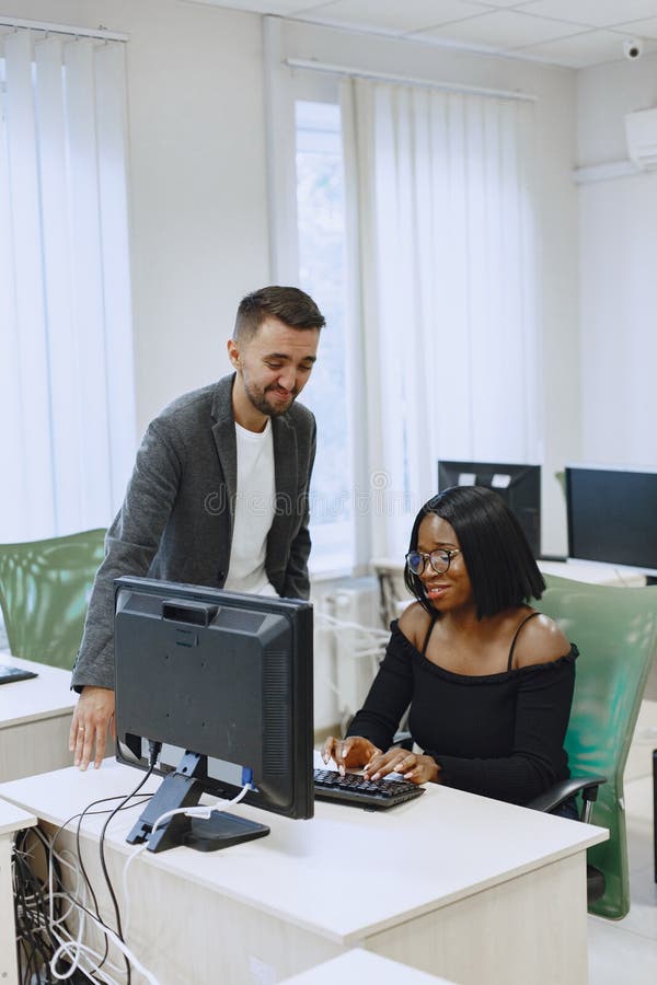 People Sitting at a Table in a Computer Room. Stock Photo - Image of ...
