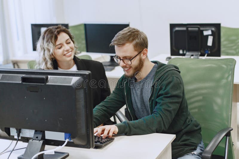 People Sitting at a Table in a Computer Room. Stock Photo - Image of ...