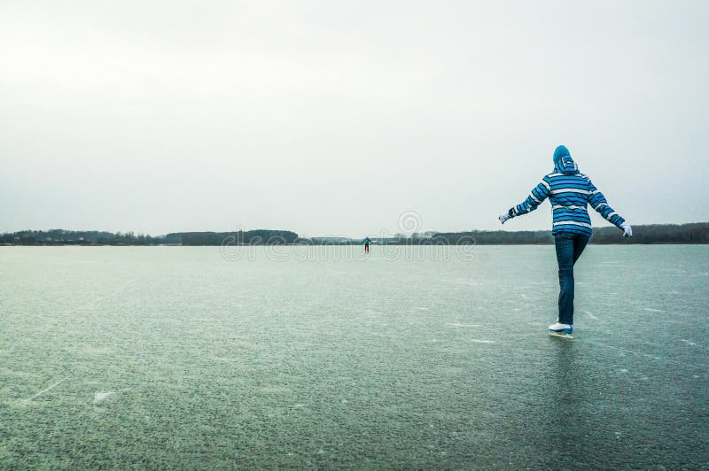 Back View of People in Winter Clothing Skating on Ice Stock Photo ...