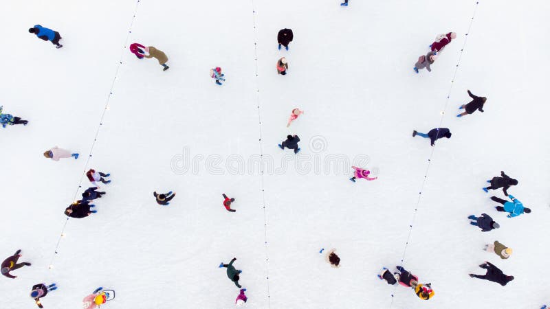 People Skating on an Open-Air Ice Skating Rink. Top View. Aerial Drone ... People Skating on an Open-Air Ice Skating Rink. Top View. Aerial Drone ...