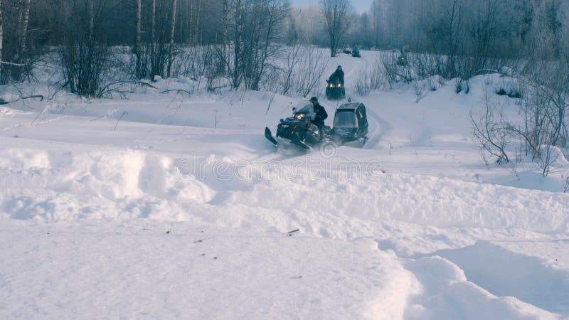 People on Snowmobiles Riding in the Winter Forest. Stock Image - Image ...
