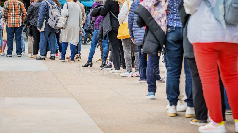 People Standing in a Long Queue Outdoors on City Street. Public Crowd ... People Standing in a Long Queue Outdoors on City Street. Public Crowd ...