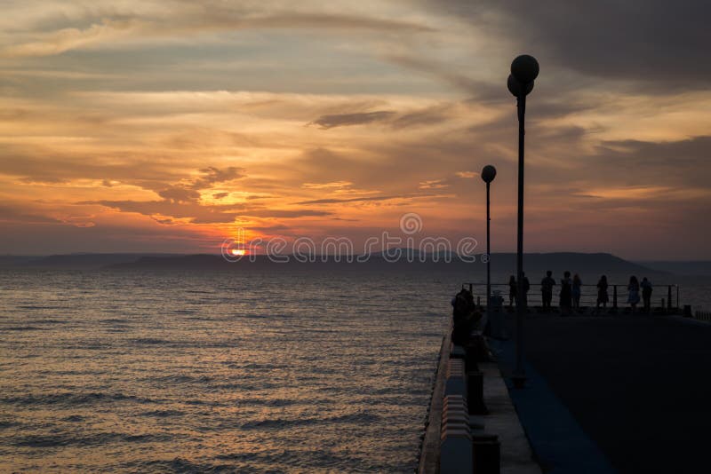 People Standing on the Pier and Watching Colorful Sunset Stock Photo ... People Standing on the Pier and Watching Colorful Sunset Stock Photo ...