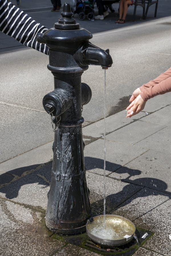 People on the Street of Vienna Drink Water from a Water Column Stock ...