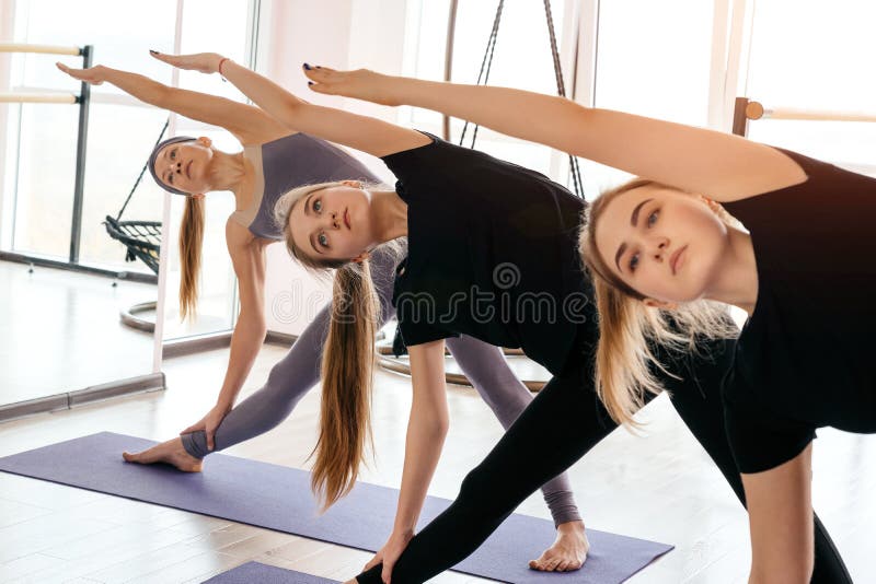 Young People Stretching in Yoga Class Doing Yoga Poses Stock Image ...
