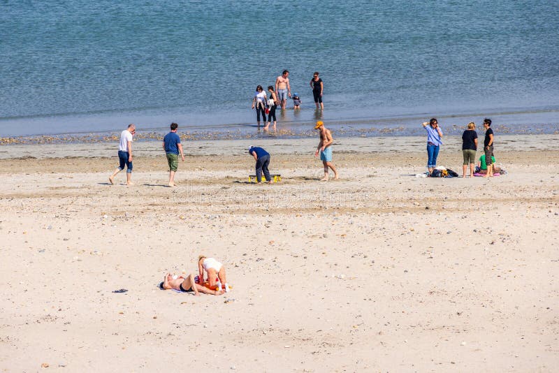People Sunbathing and Walking on a Sand Beach in the Sunshine Editorial ...