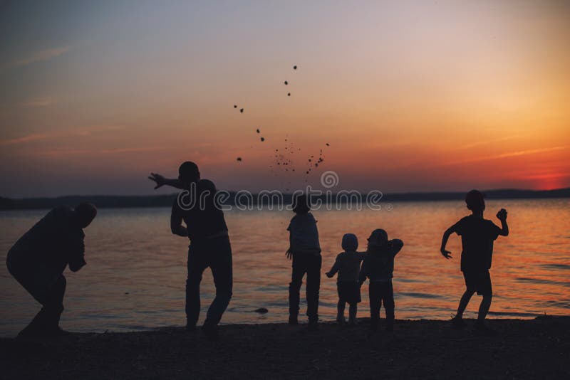 A Man Throwing Stones Into The Arctic Sea Stock Image - Image of ocean ...