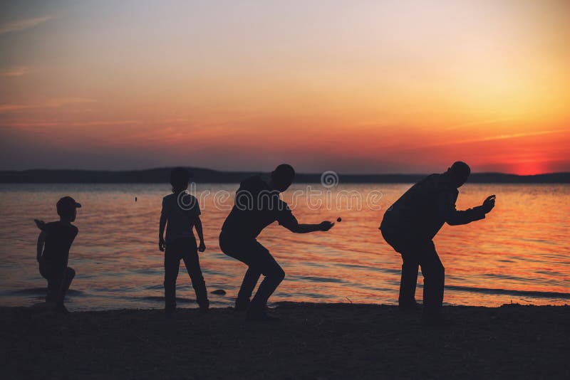 People Throwing Stones into the Wat Stock Photo - Image of back, father ...
