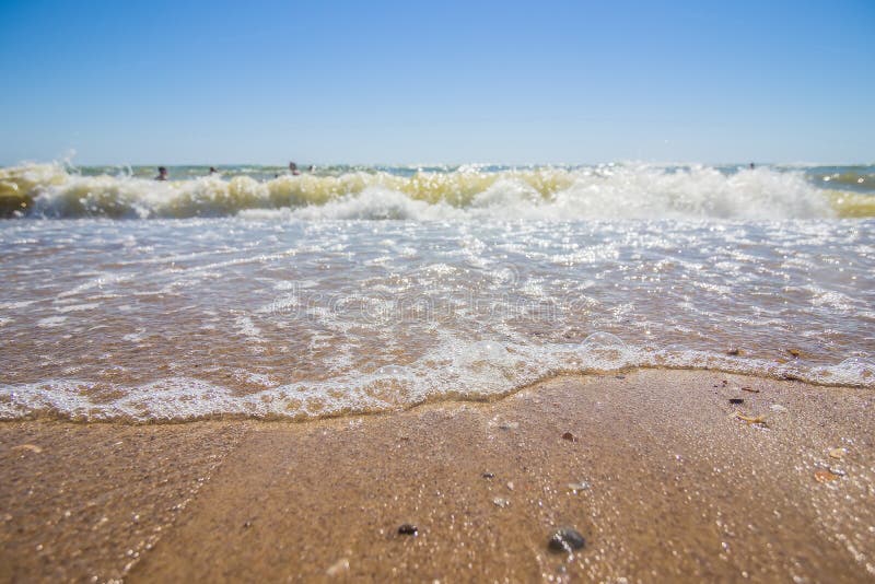 People Swimming in the Rough Sea. View from the Sandy Beach Stock Photo ...