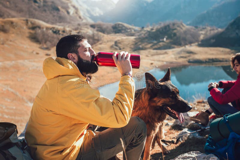 People Taking a Break, Relaxing during a Hike. Man Drink Water Stock ...