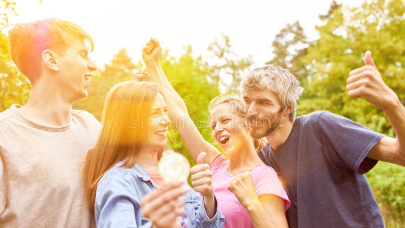 People in the Team Cheer As a Winner with a Medal Stock Image - Image ...