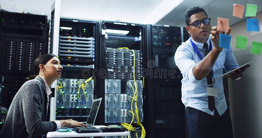 People, Technician and Planning with Sticky Note in Server Room for Priority on Network Security ...