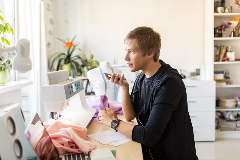 Fashion Designer with Smartphone Working at Studio Stock Photo - Image ...