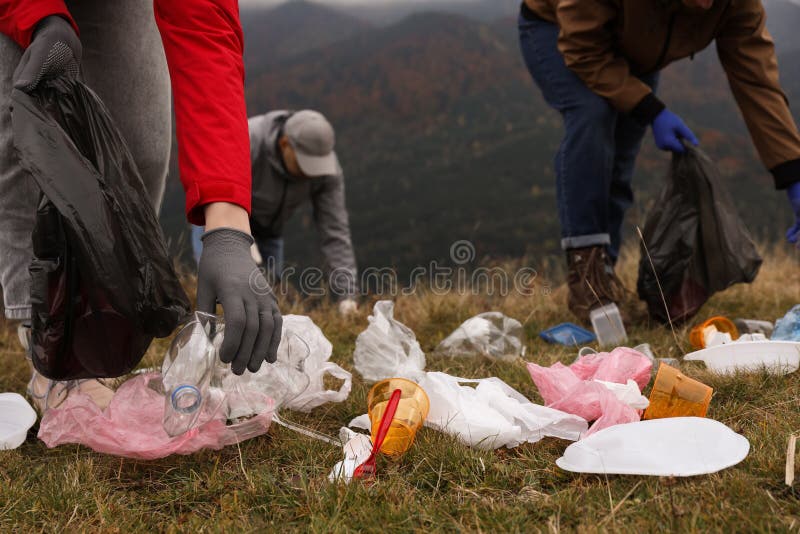 People with Trash Bags Collecting Garbage in Nature, Closeup Stock ...