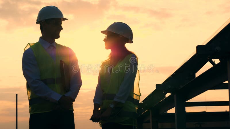 People in Uniform Talking on a Sunset Background, Side View. Stock ...