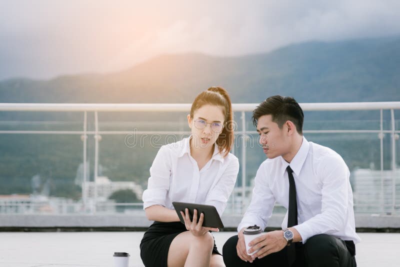 People Using Digital Tablet at Outside Business Office Together. Stock ...