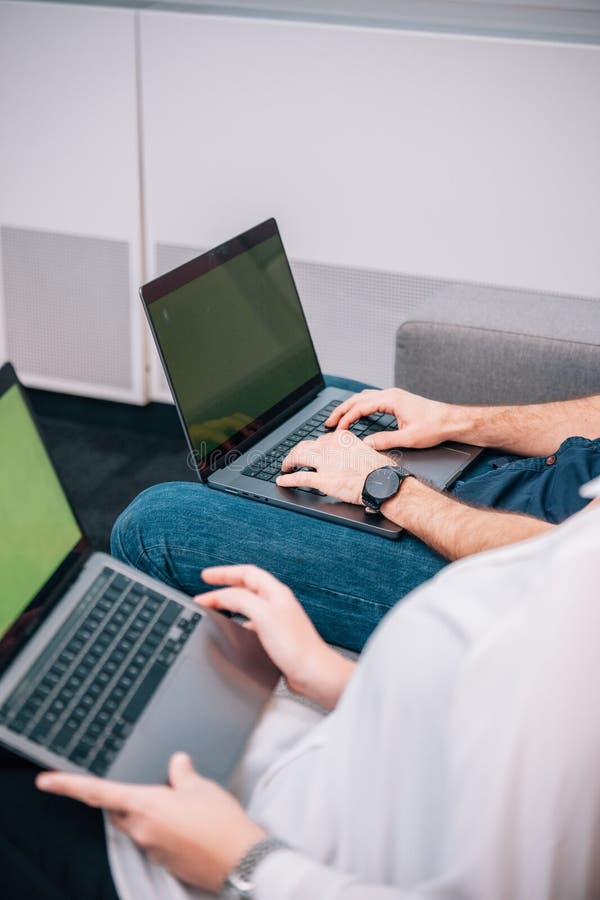 People Using Laptops while Seated on a Cozy Sofa: Workspace Environment ...