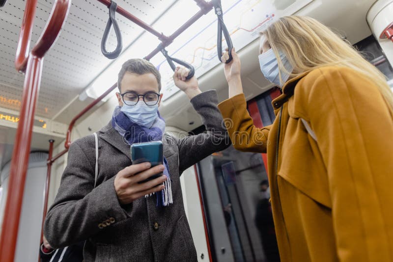 People Using Phone in Train Wearing Covid-19 Face Mask Stock Image ...