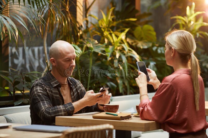 People Using Phones in Cafe Stock Photo - Image of smiling, women ...
