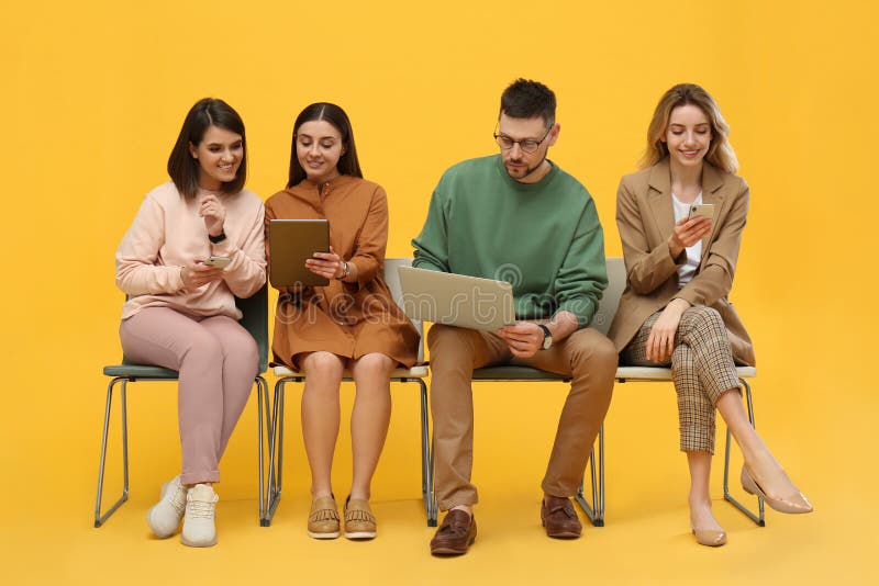 People Waiting for Job Interview on Yellow Background Stock Photo ...