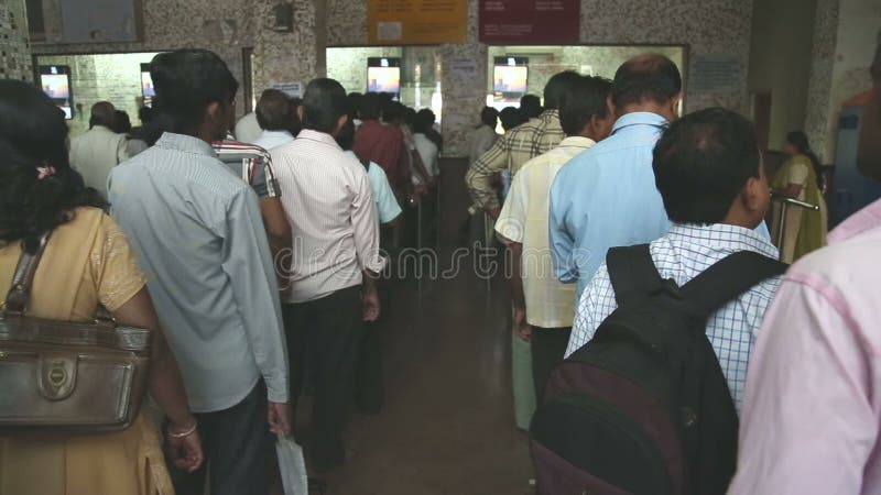 People Waiting in Queue at the Booking Office of a Train Station. Stock ...