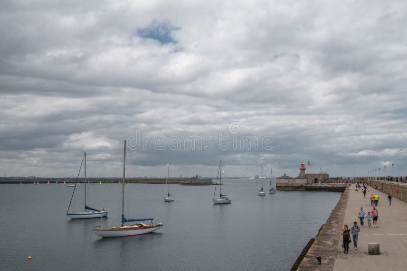 People Walking Along the Quay with East Pier Lighthouse in the ...