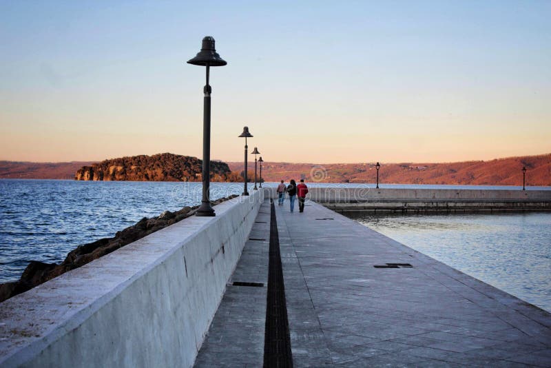 Walking Alongside the Sea at Sunset Stock Photo - Image of city, people ...