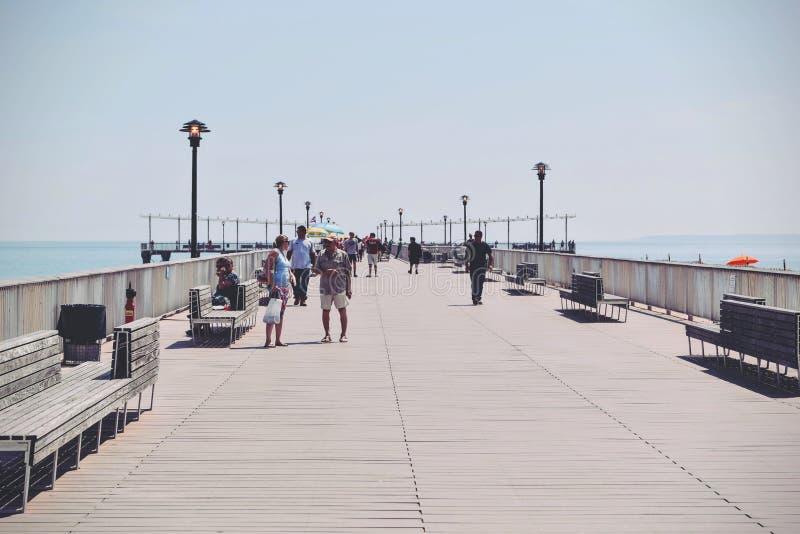 People Walking On A Beige Concrete Bridge Pathway Near Seashore During ...