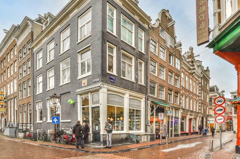 People Walking Down a Street in Front of a Building Editorial ...