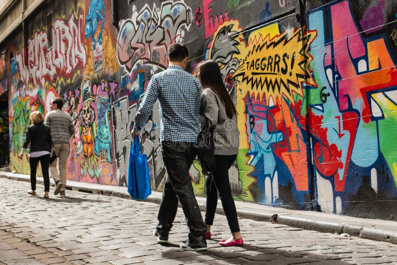 People Walking Past Graffiti Wall Editorial Photography - Image of ...