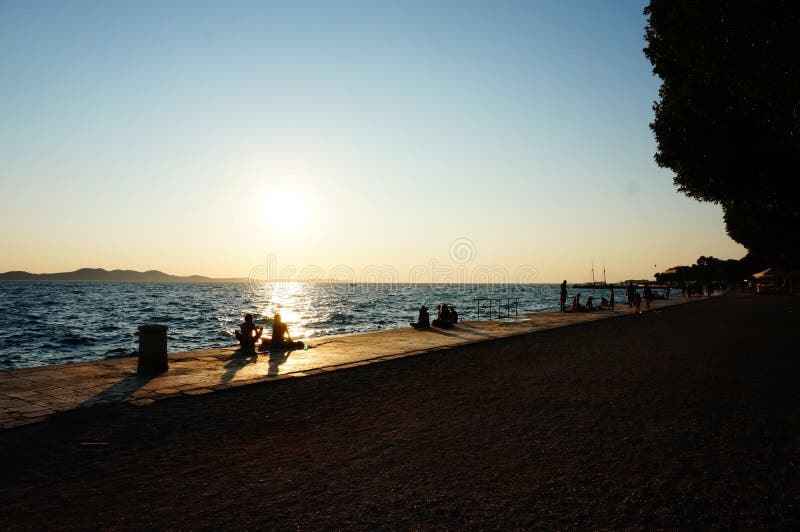 People walking promenade stock photo. Image of silhouette - 76079556