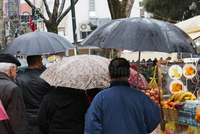 People walking in the rain editorial photography. Image of blue - 117757307
