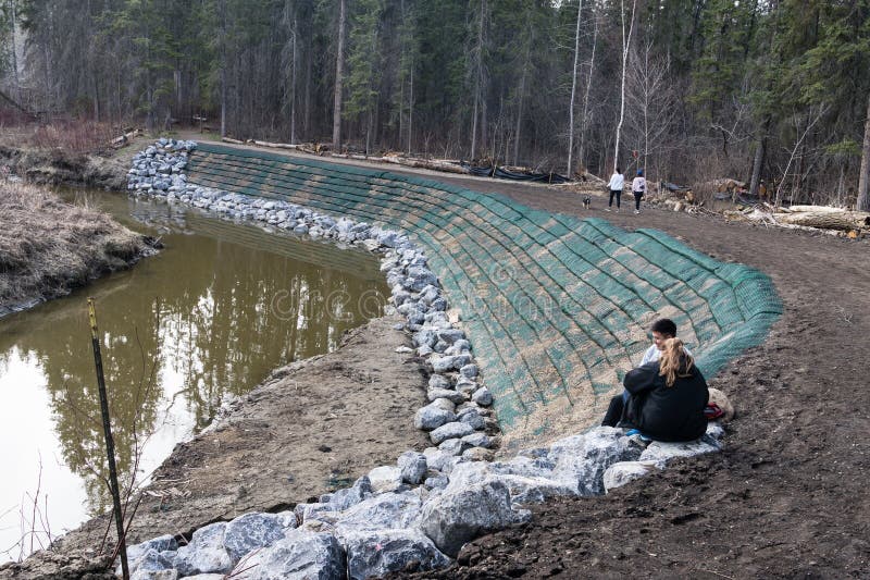 People Walking and Resting Along Erosion Control Project in Progress at ...