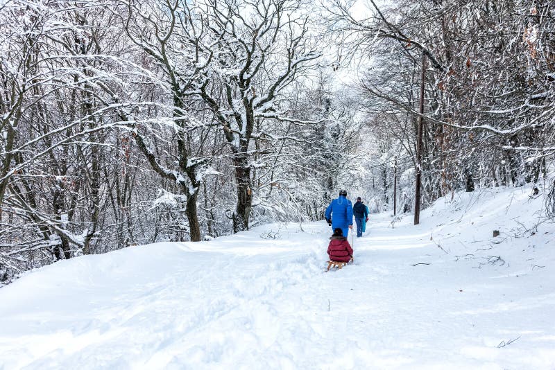 People Walking On The Snow In A Mountain Path Stock Photo - Image of ...