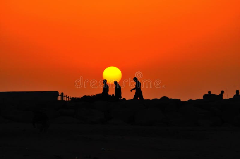 People walking on sunset stock image. Image of light, gold - 7189873
