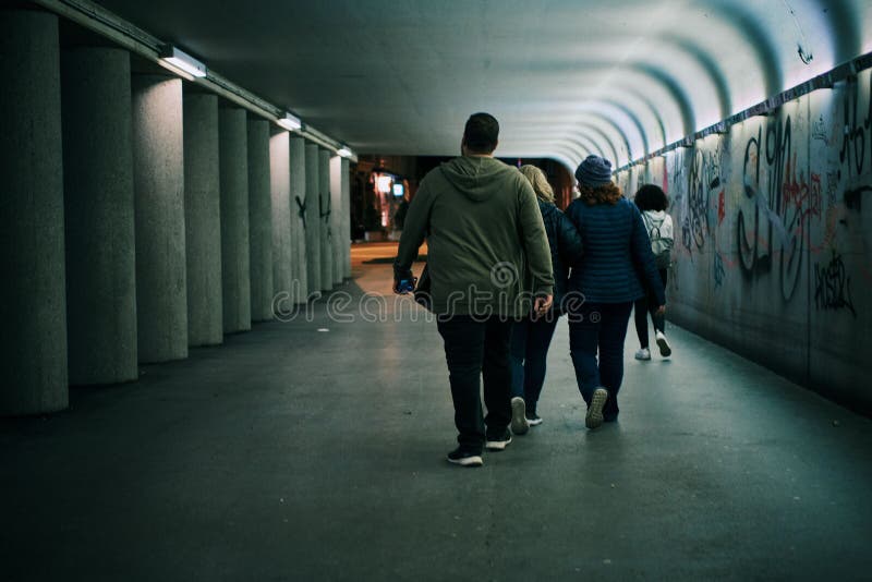 People Walking through an Underground Passageway, Tunnel at Night ...