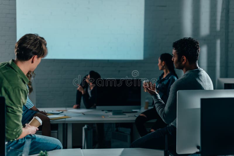 People Watching Presentation in Office at Nighttime Stock Photo - Image ...